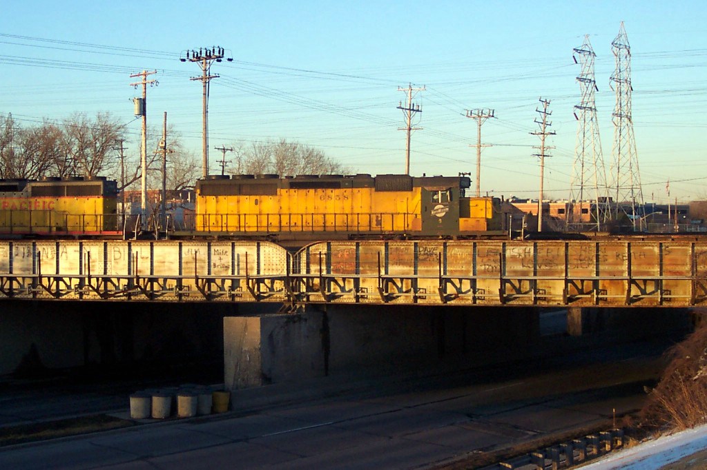 CNW 6858 works at Butler atop the Capitol Dr. bridge